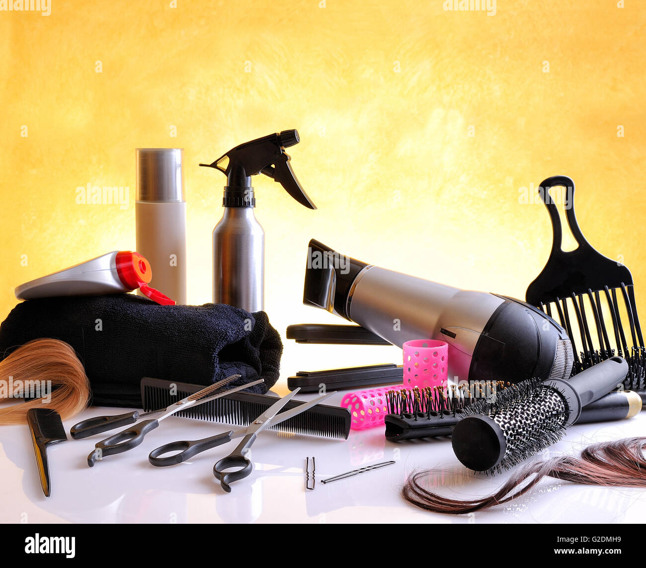 Set hairdressing articles exposed on a glass table and yellow ...