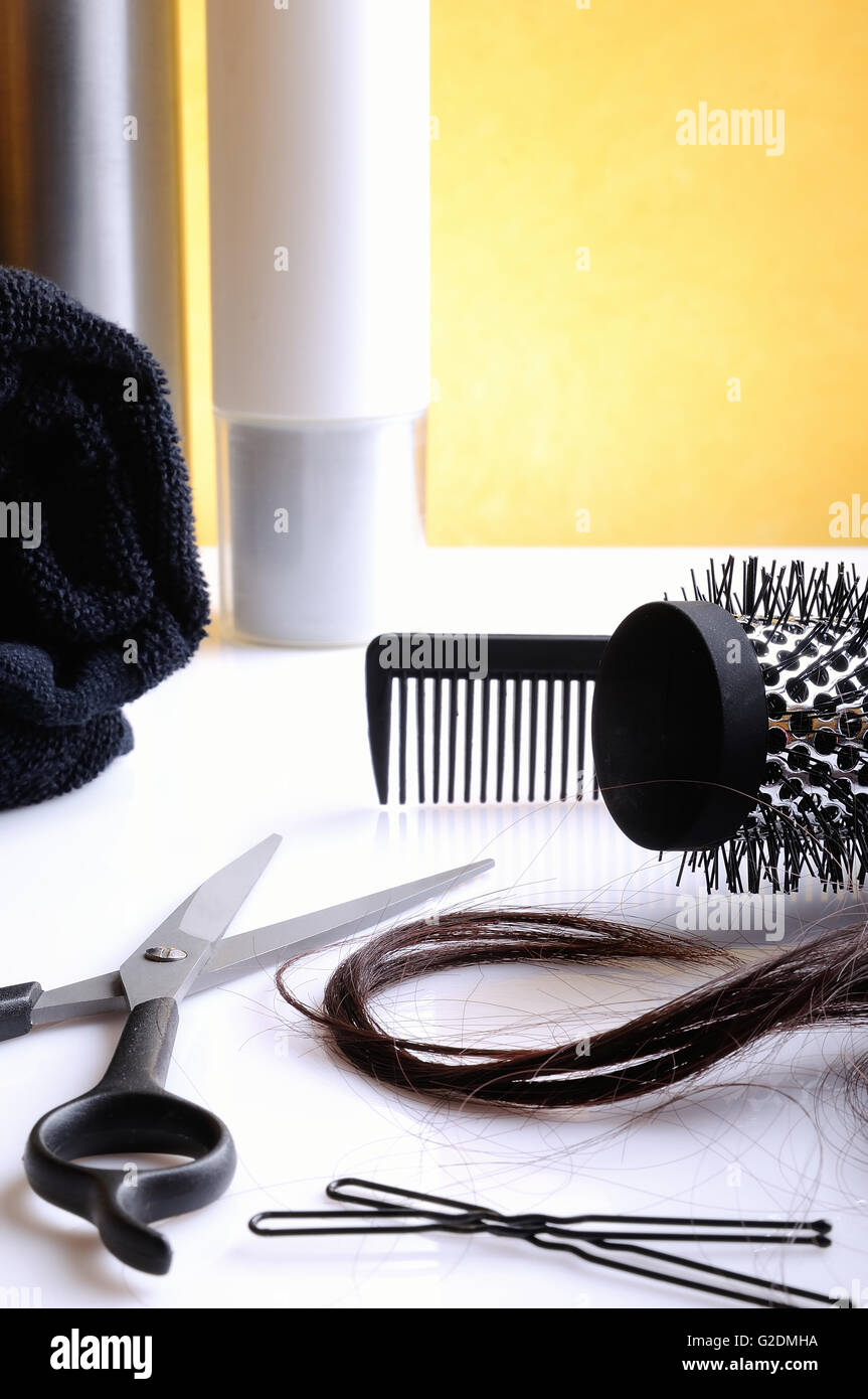 Set hairdressing articles exposed on a glass table and yellow ...