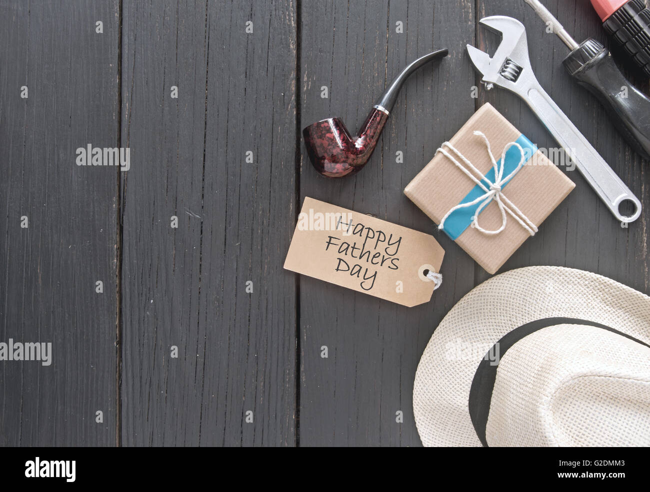 Fathers day gift box with a label, tools, hat and pipe Stock Photo - Alamy