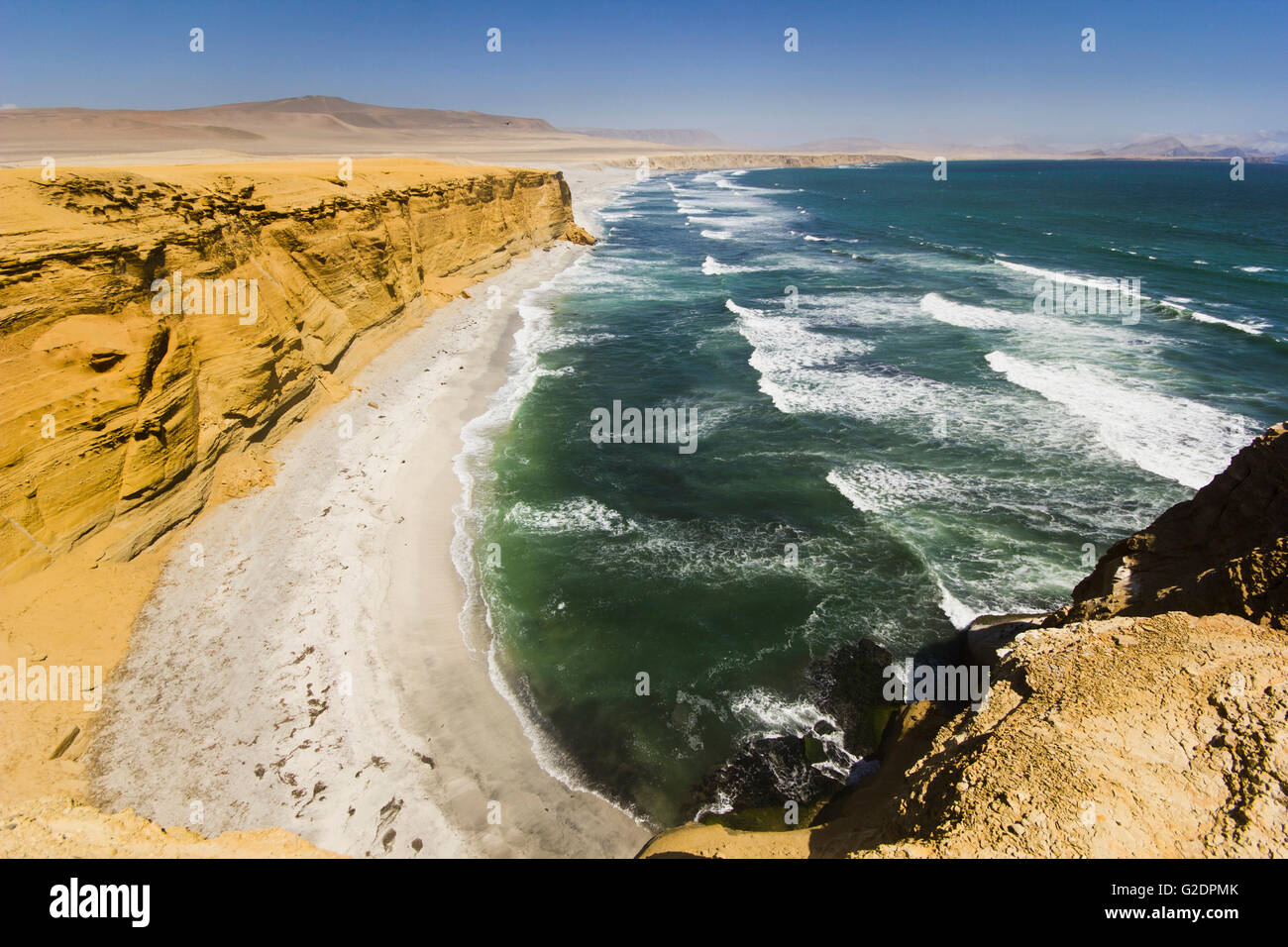 sea waves on shore of pacific ocean with yellow rocks in desert in peru ...