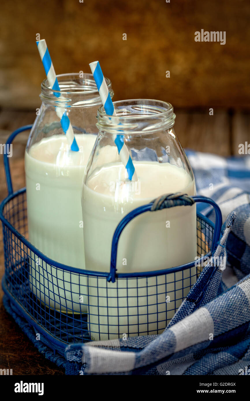Milk bottles with straws Stock Photo - Alamy