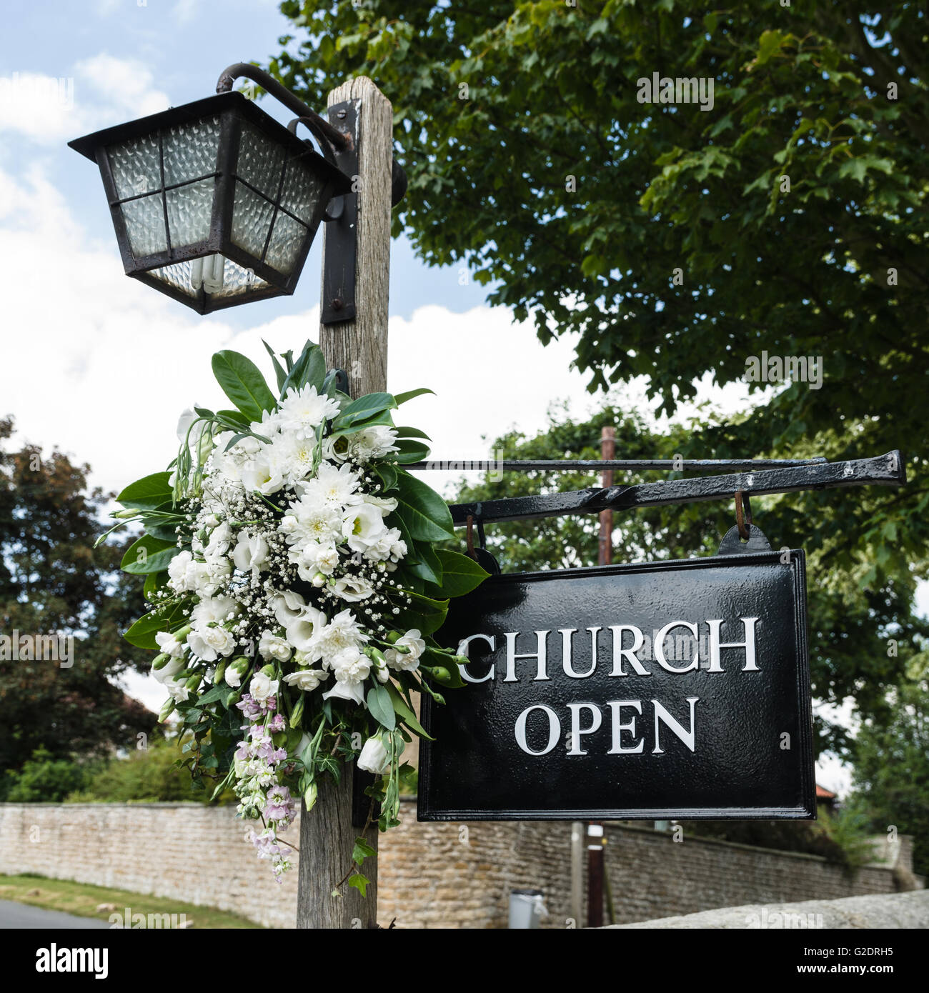 UK Church open sign, with flowers and lamp on oak pole Stock Photo - Alamy