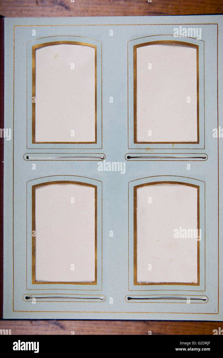 four ancient blank photo frames in old and used photo album, background ...