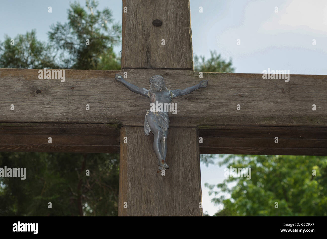 iron sculpture of Jesus on a wooden cross Stock Photo - Alamy