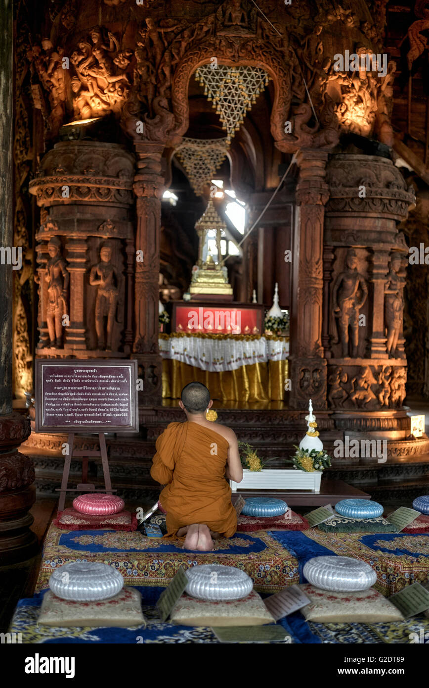 Solitary monk praying at the Sanctuary of truth Buddhist Hindu temple ...