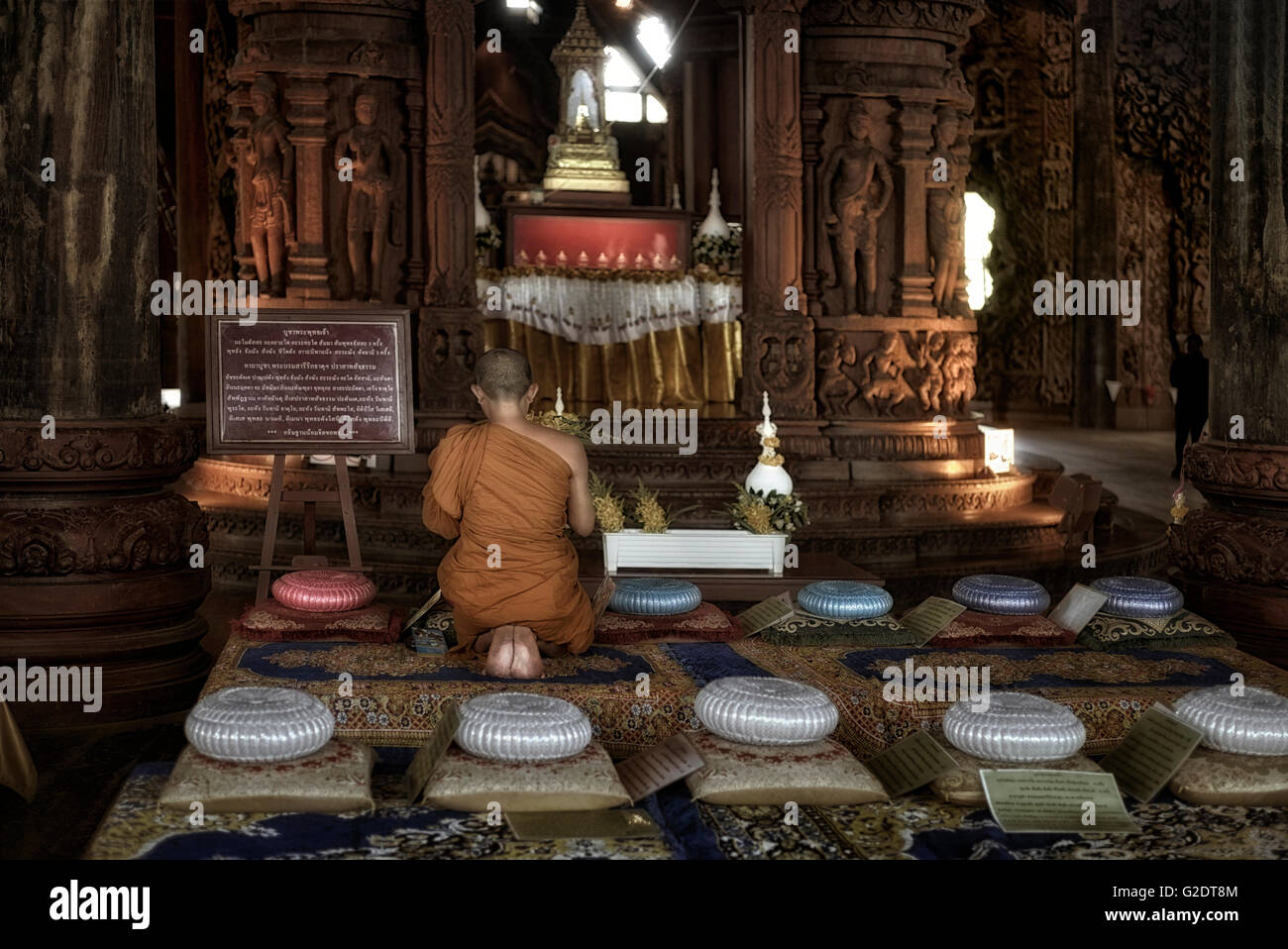 Solitary monk praying at the Sanctuary of truth Buddhist Hindu temple ...