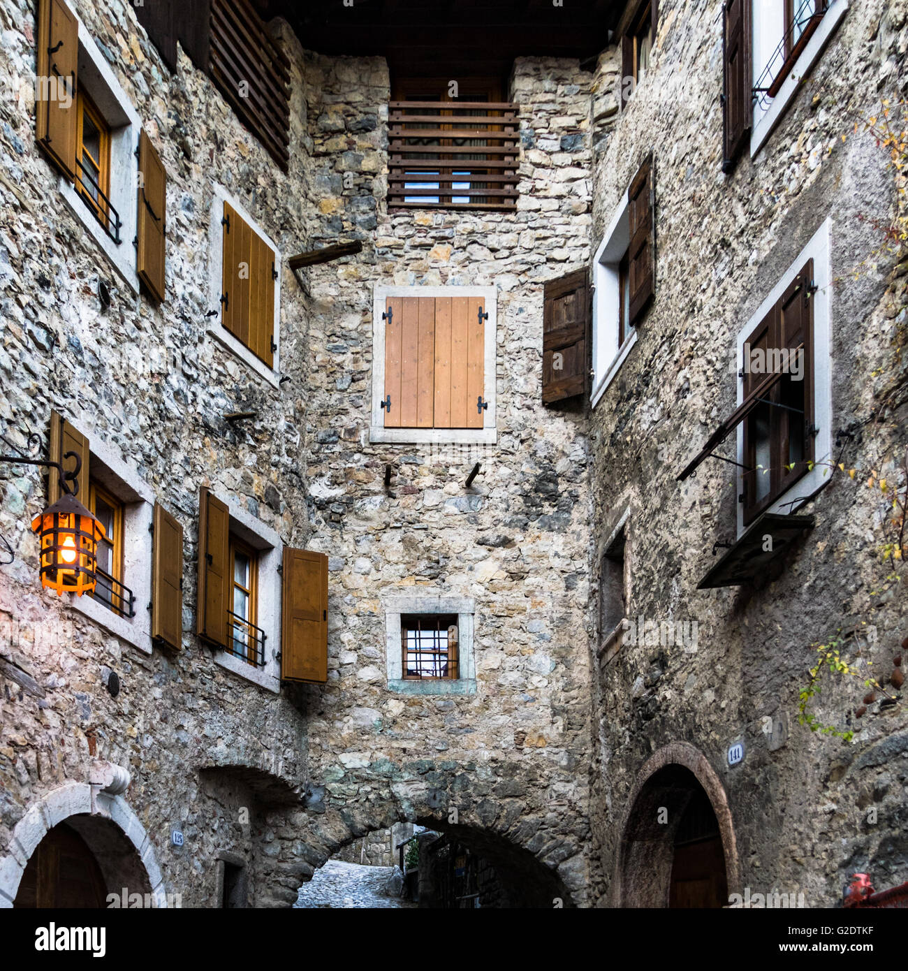 Many windows overlook in a narrow alley in a Medieval Italian village ...