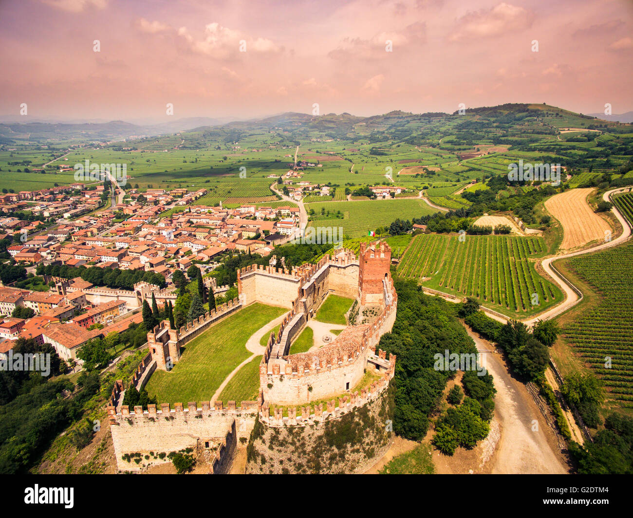 view of Soave (Italy) surrounded by vineyards that produce one of the ...