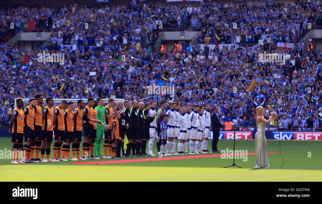 Soprano singer Emily Haig sings the national anthem as the teams line ...