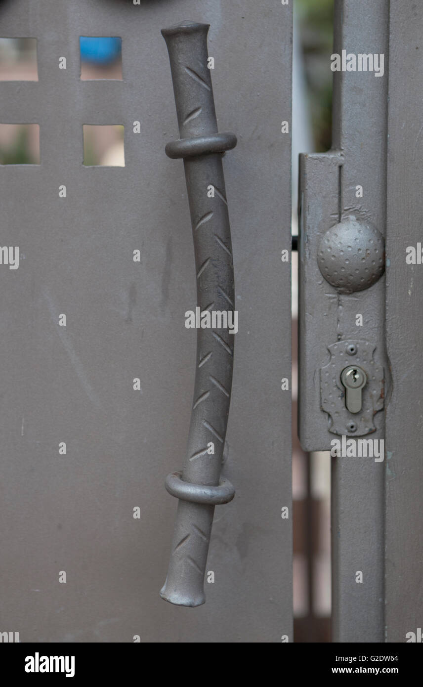 Long gray entrance gate handle close-up Stock Photo - Alamy