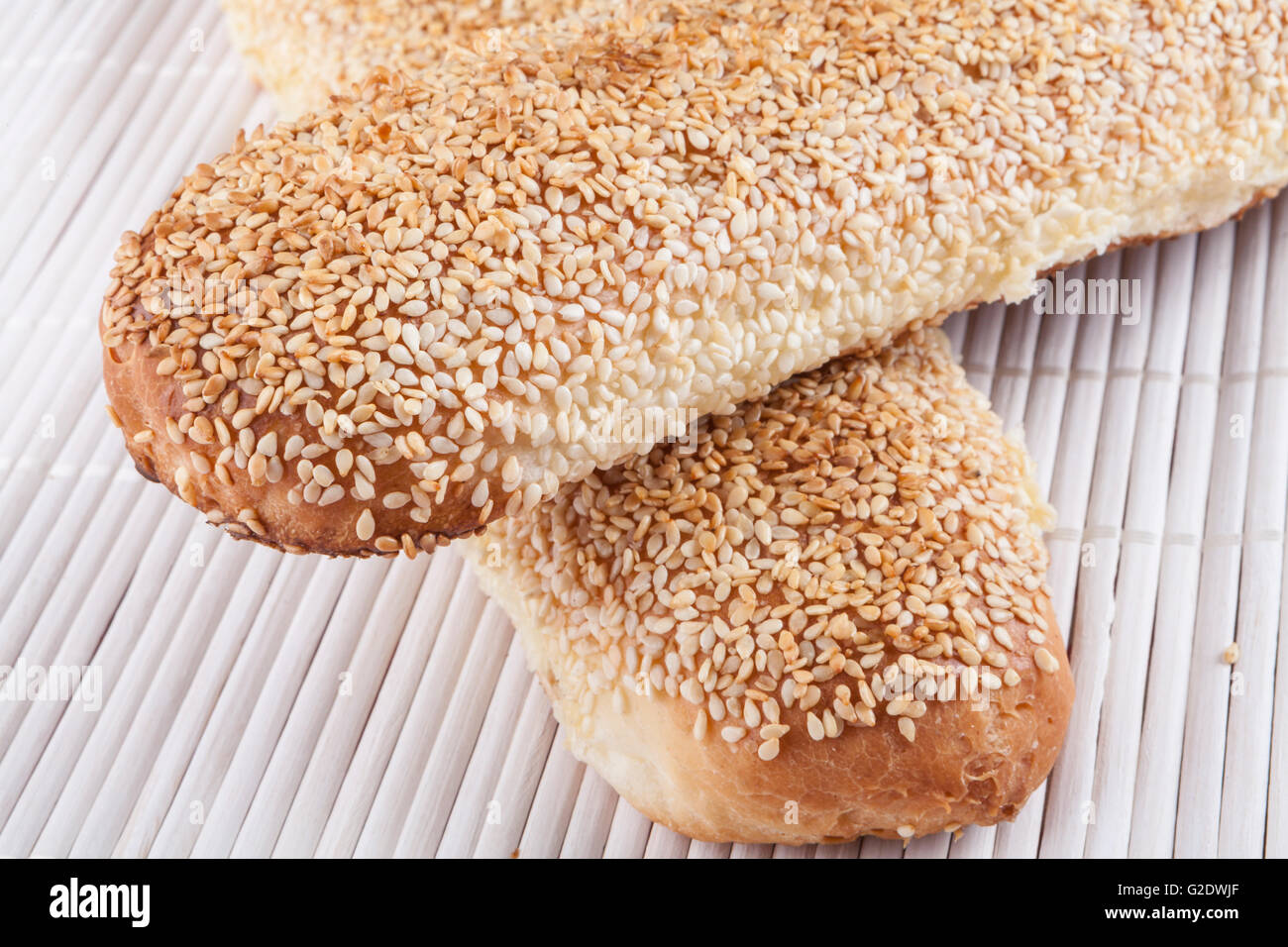 Sesame buns on white wood textured background Stock Photo - Alamy