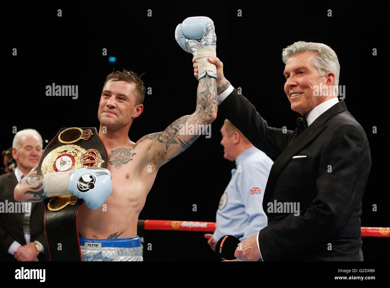 Ring announcer Michael Buffer lifts the arm of Ricky Burns after he ...