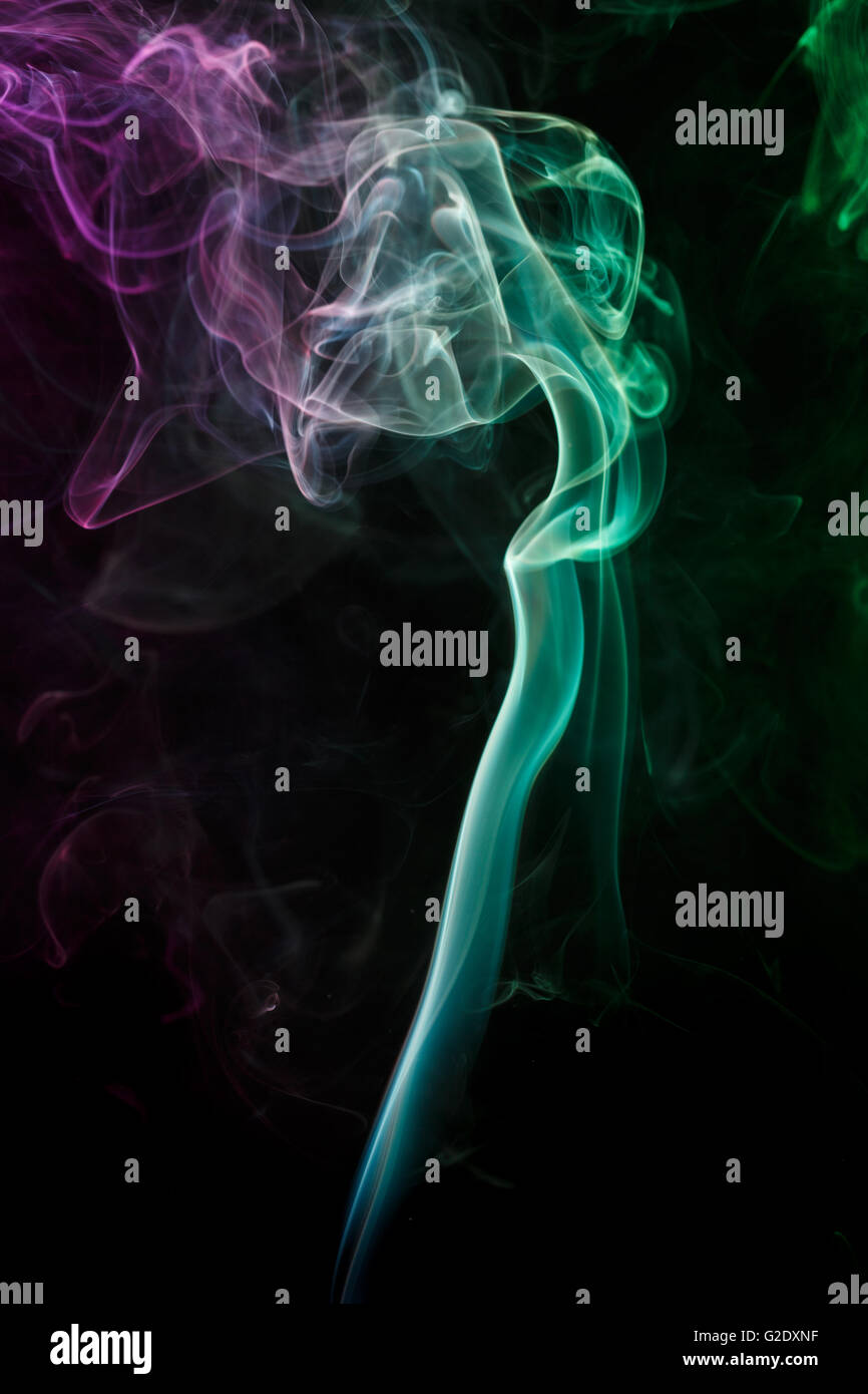 Abstract art. Color purple emerald smoke from the aromatic sticks on a ...