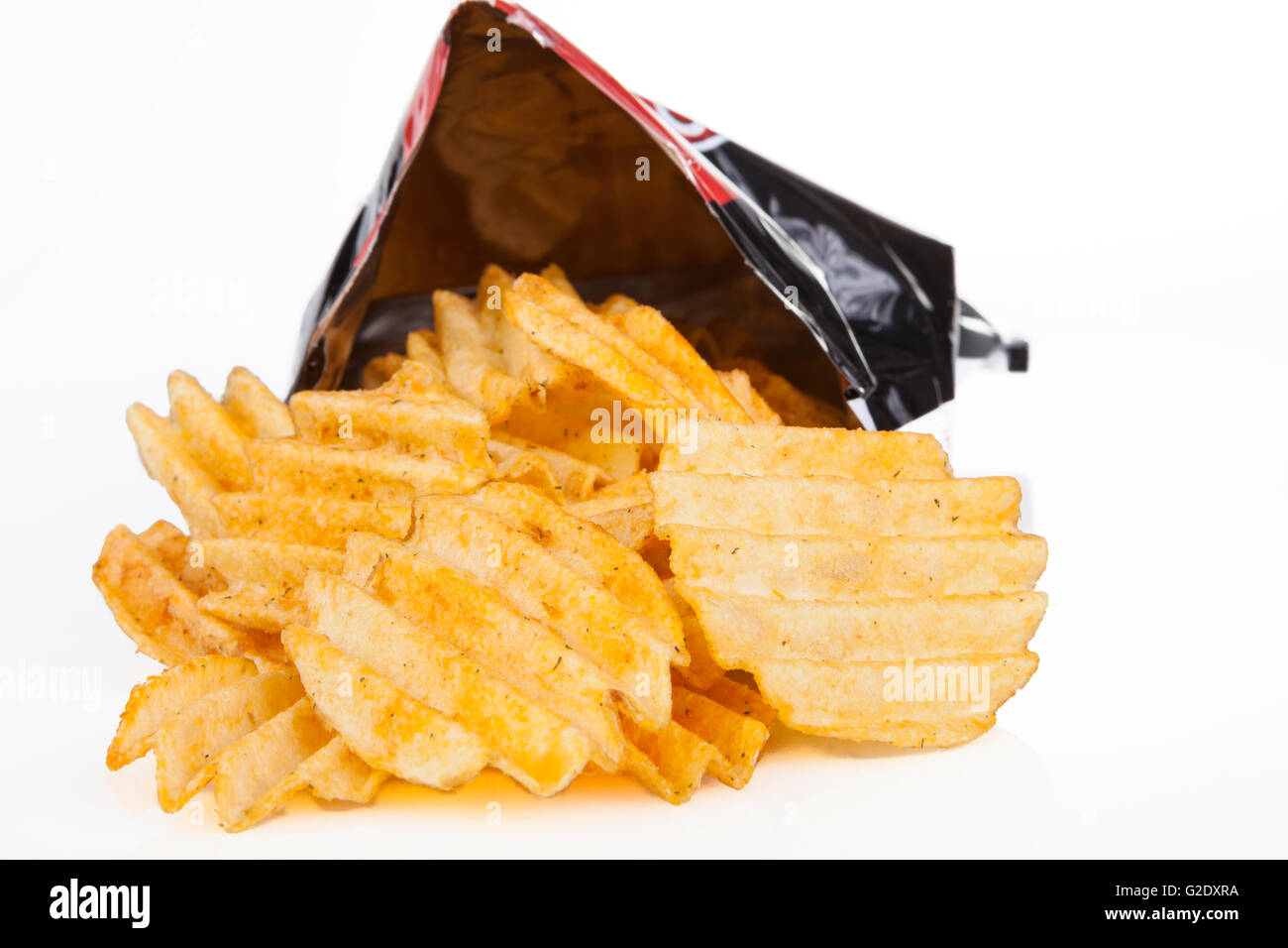 Golden poatato chips pouring out os a bag on white background Stock ...