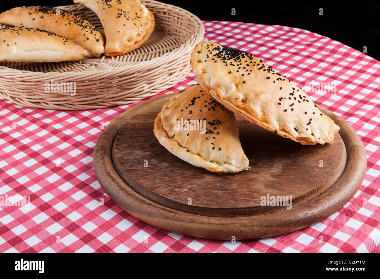 Two Filled pastry close-up in on round wood board Stock Photo - Alamy
