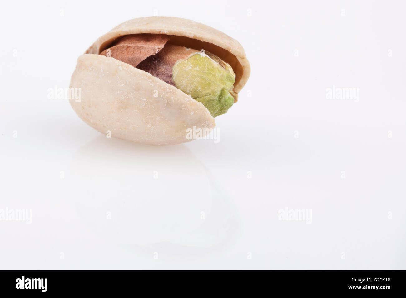 Single salted pistacio macro shoot isolated on white background with ...