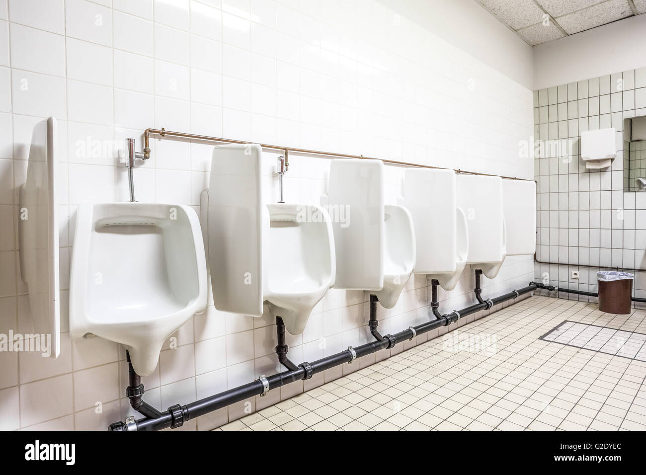 urinals in an old building for men only Stock Photo - Alamy