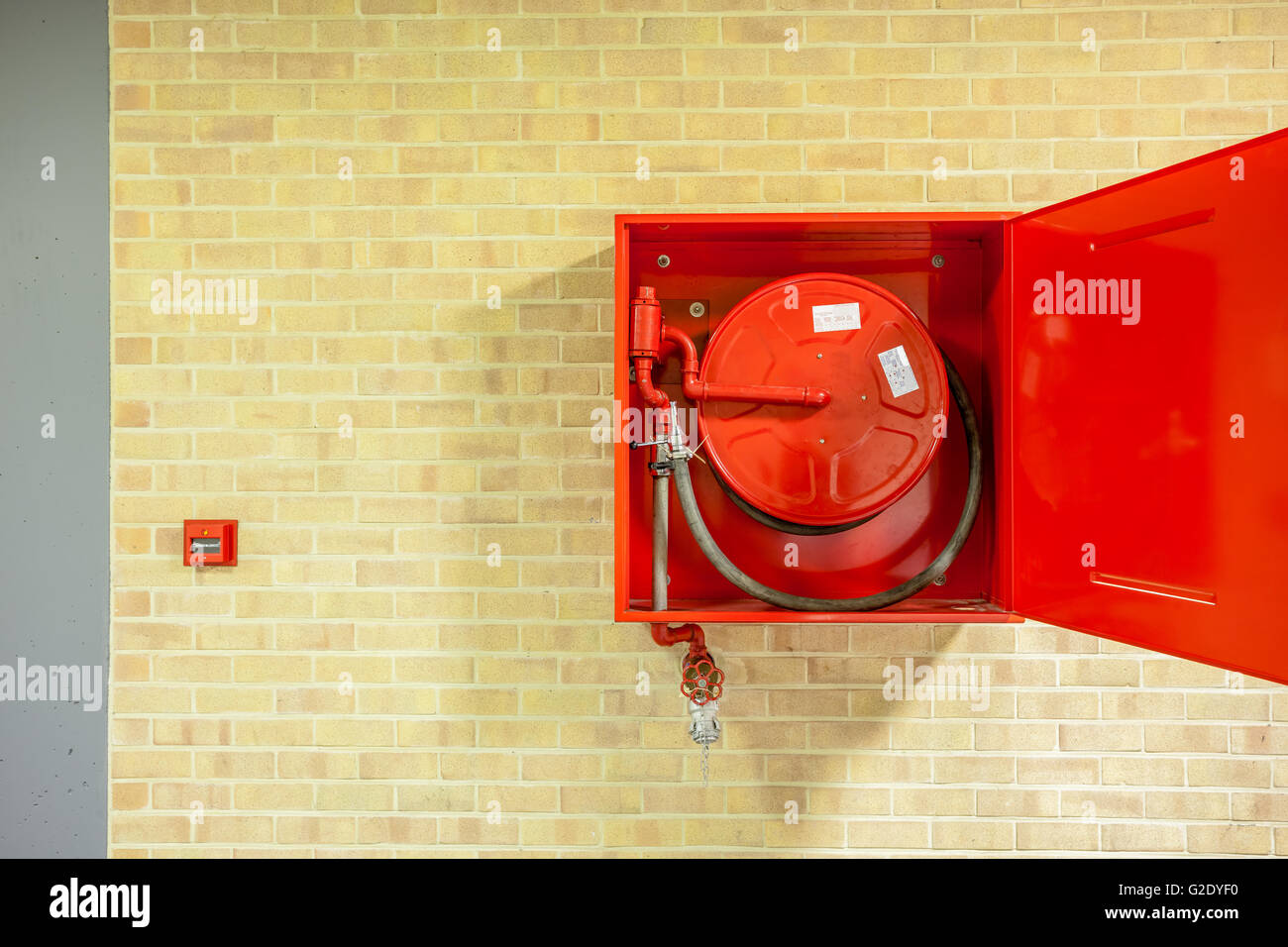 in the hallway of a nice building, there is an fire hose Stock Photo ...