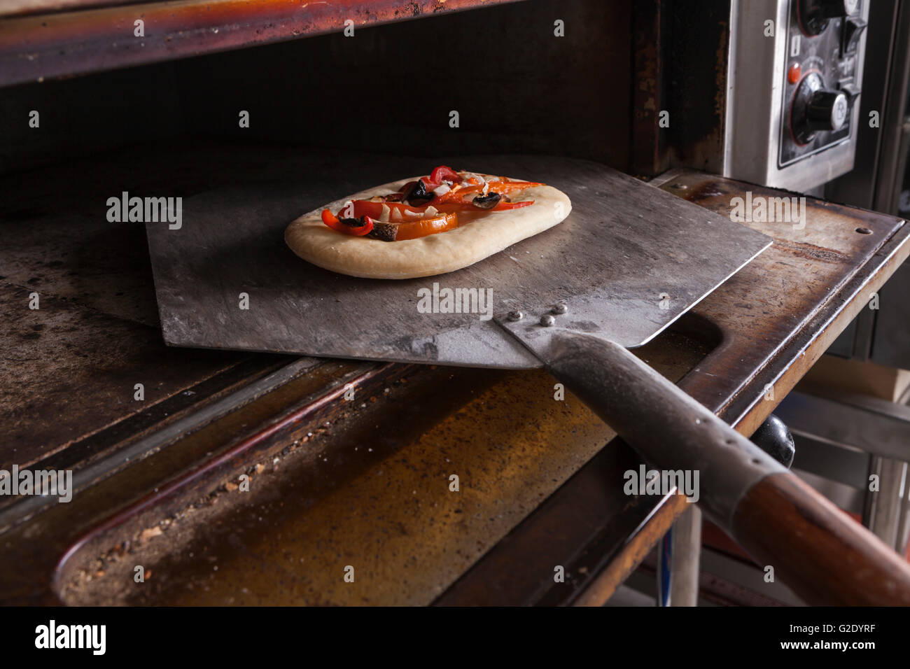 Vegetble pastry going into hot oven on spoon Stock Photo - Alamy