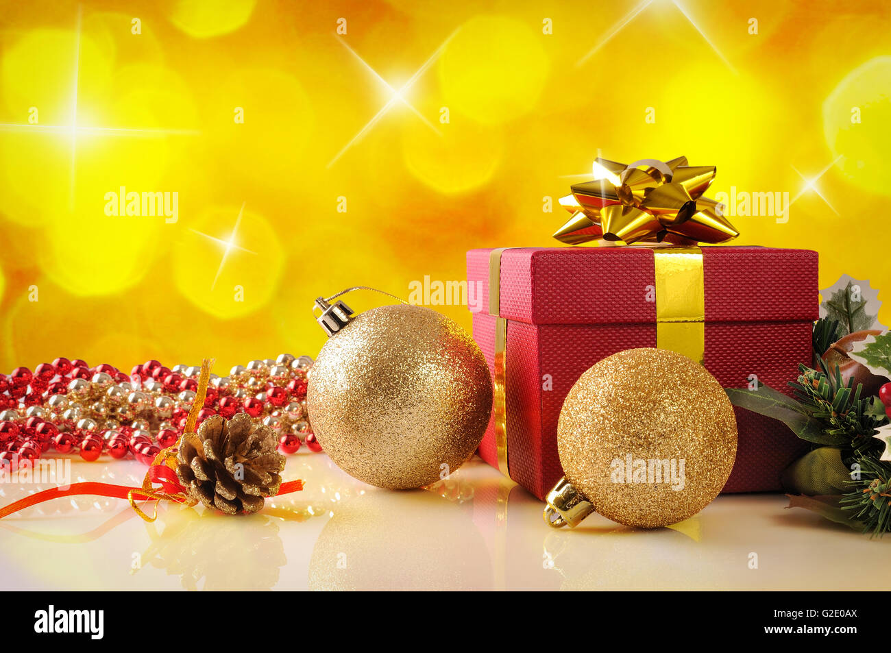 Yellow Christmas decoration on a white table methacrylate. With red ...
