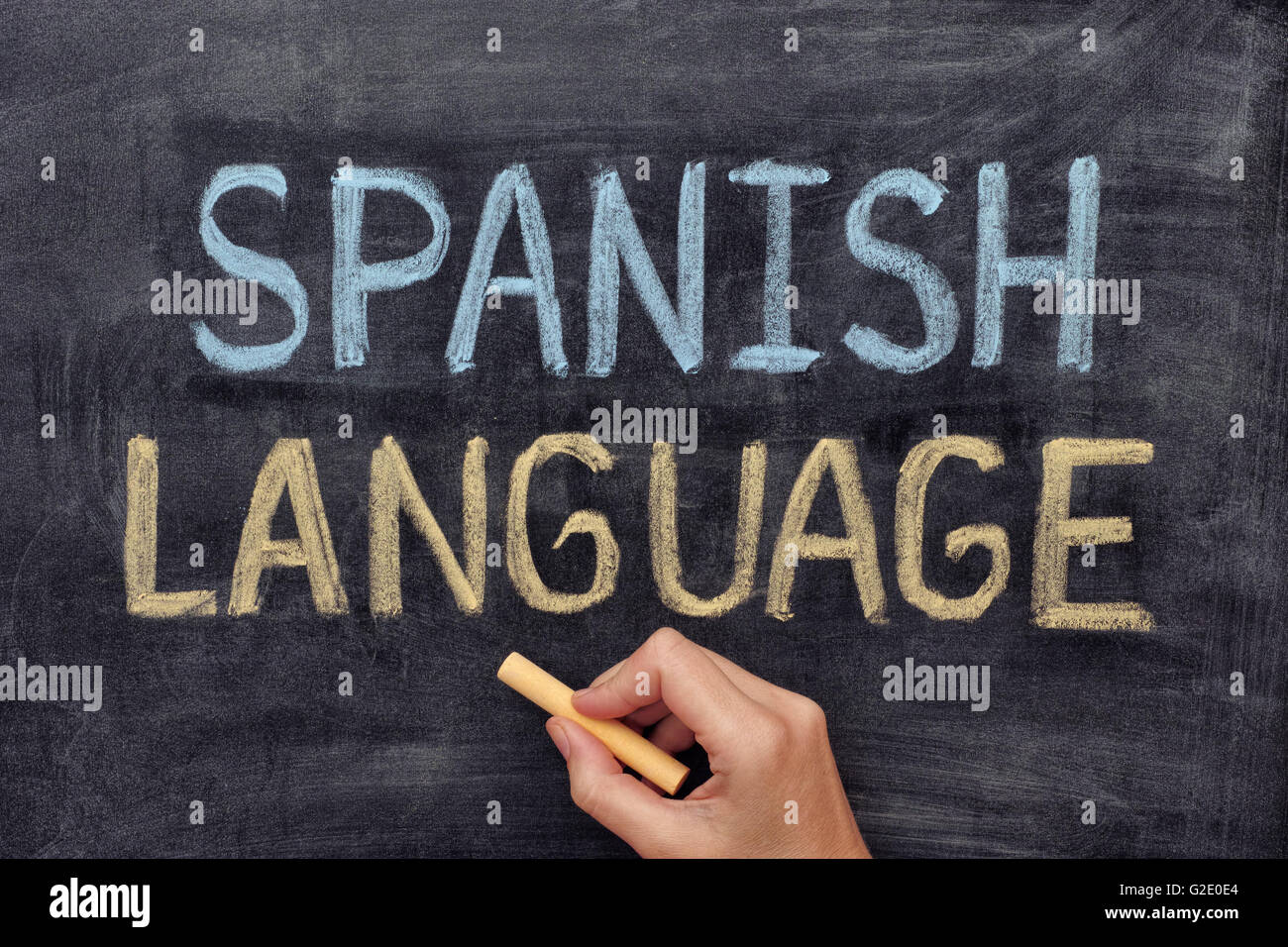 Spanish language. Hand drawing Spanish Language on blackboard. Close up ...