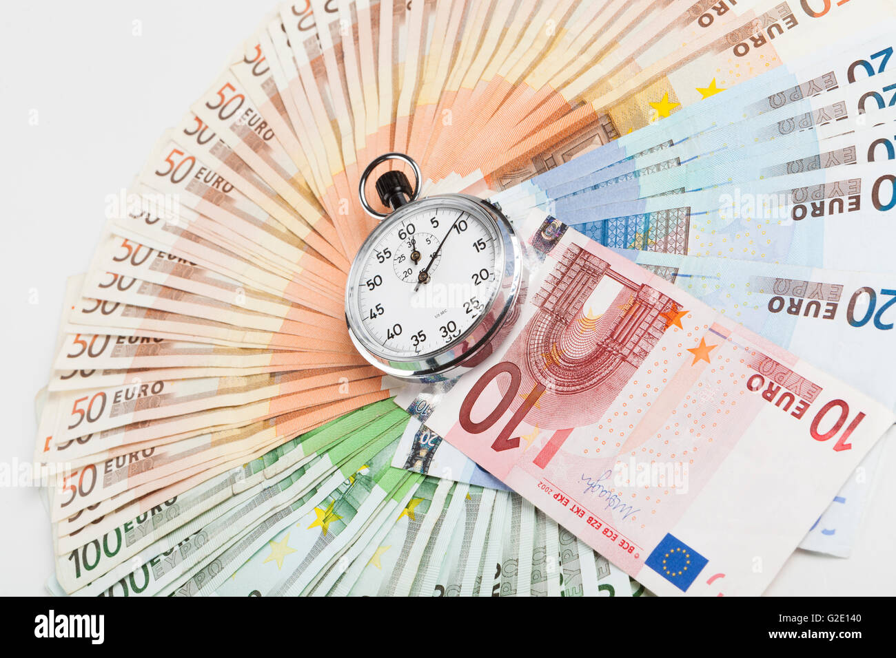 Silver analog stopwatch in a middle of euro banknotes circle Stock ...