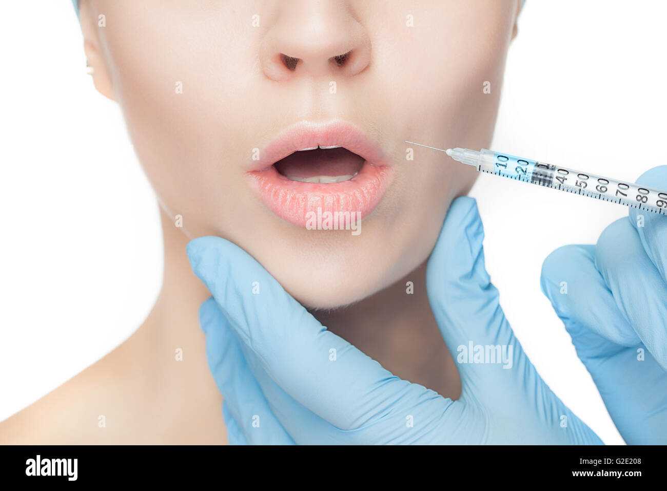 Attractive surprised and scared woman at plastic surgery with syringe ...