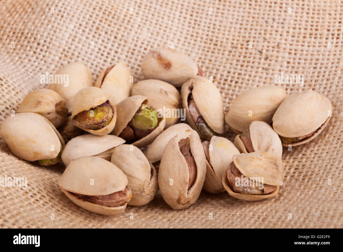 Many pictacio nuts on brown natural whole Stock Photo - Alamy
