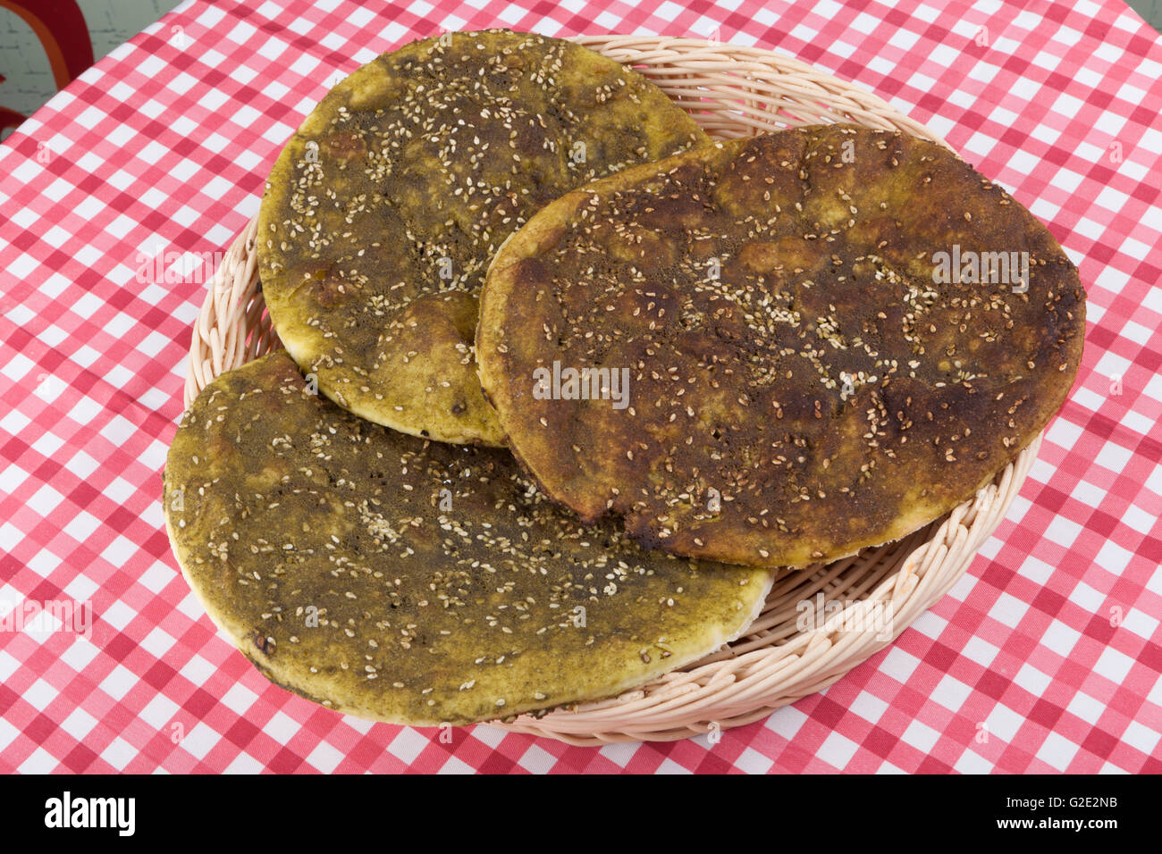 Pita bread with zaatar green middle eastern herb on red table Stock ...