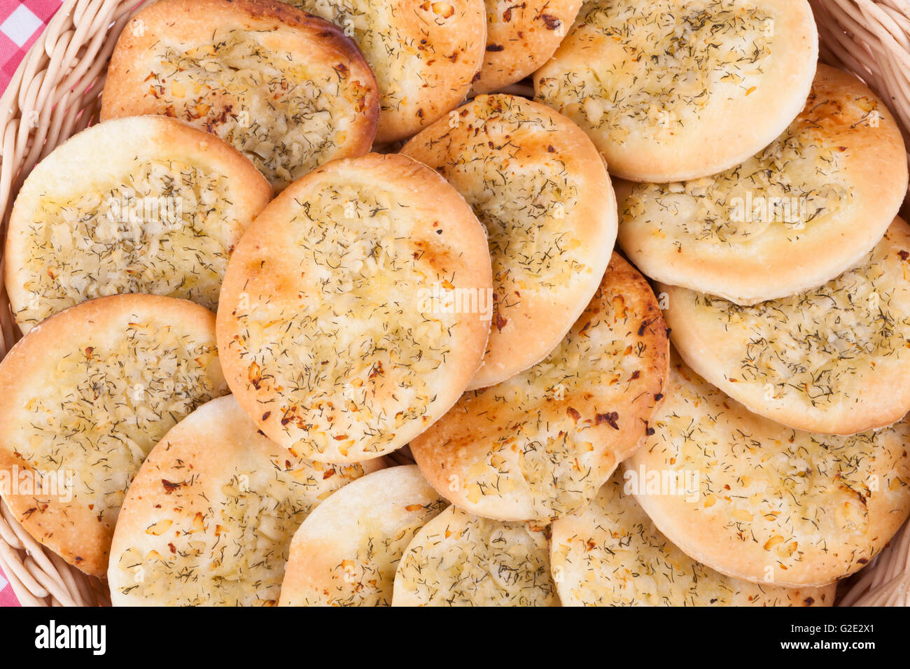 Round garlic flatbred with herbs in basket top view Stock Photo - Alamy