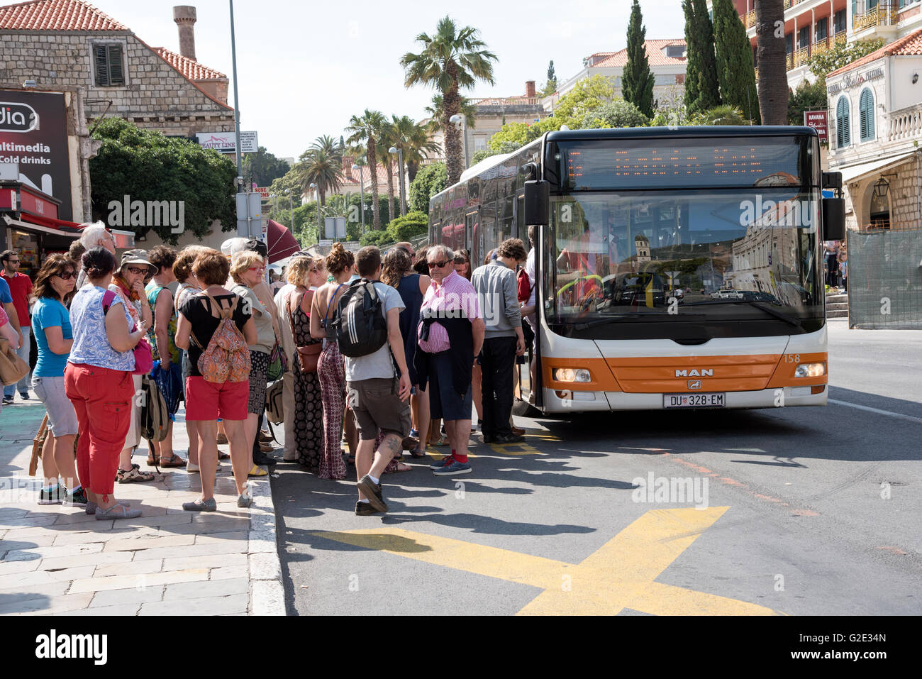 DUBROVNIK BUS SERVICE CROATIA. Passengers queue and board a local ...