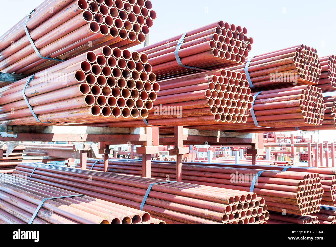 Steel Pipes bunch on the rack in warehouse Stock Photo - Alamy