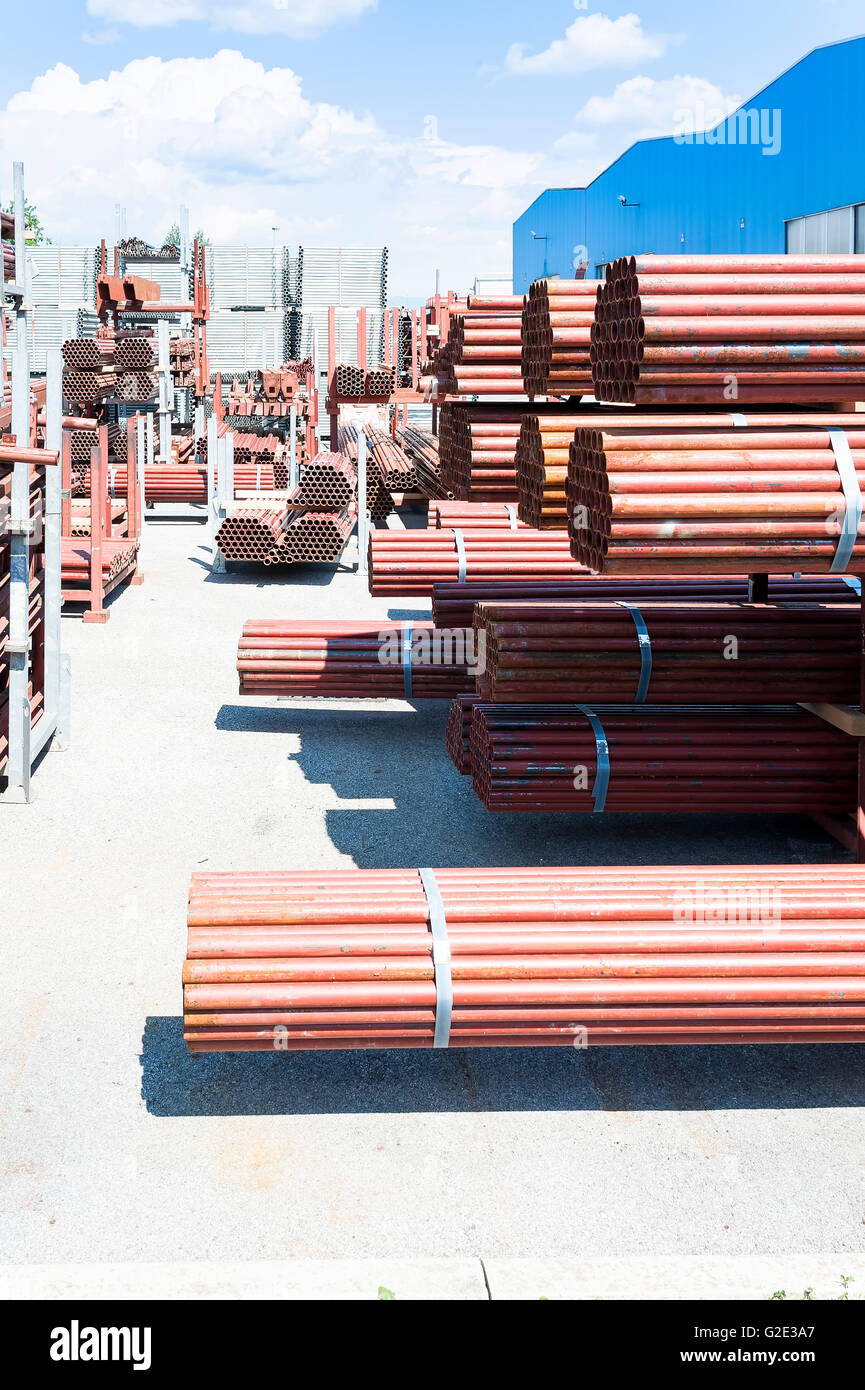 Steel Pipes bunch on the rack in warehouse Stock Photo - Alamy