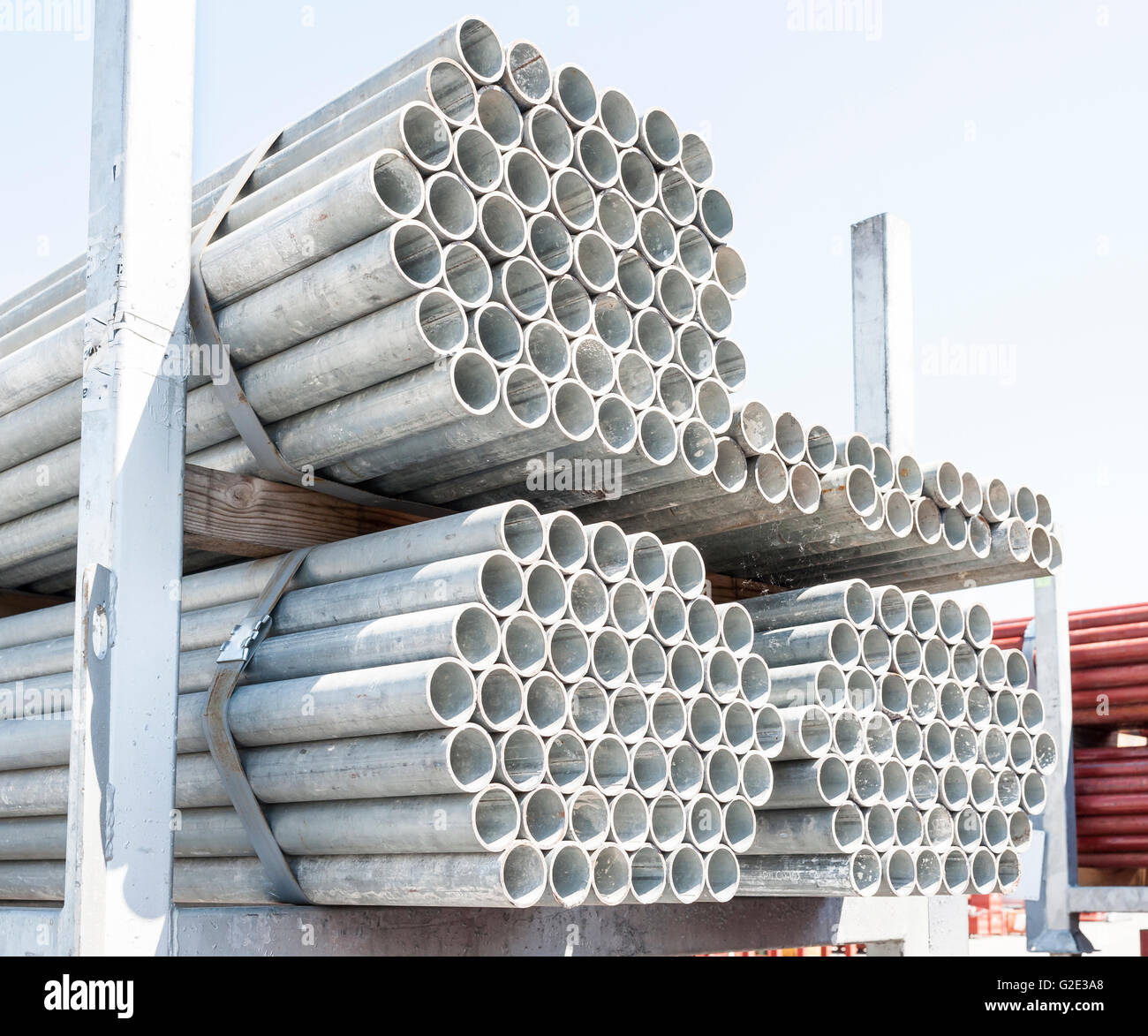 Steel Pipes bunch on the rack in warehouse Stock Photo - Alamy