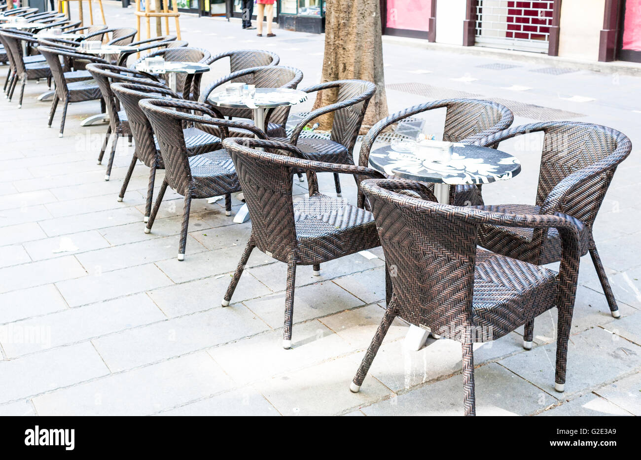 A row of small tables of a cafe on a pedestrian street Stock Photo - Alamy