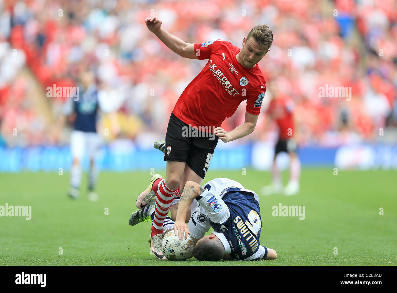 Barnsley's Sam Winnall (left) and Millwall's Shaun Williams battle for ...
