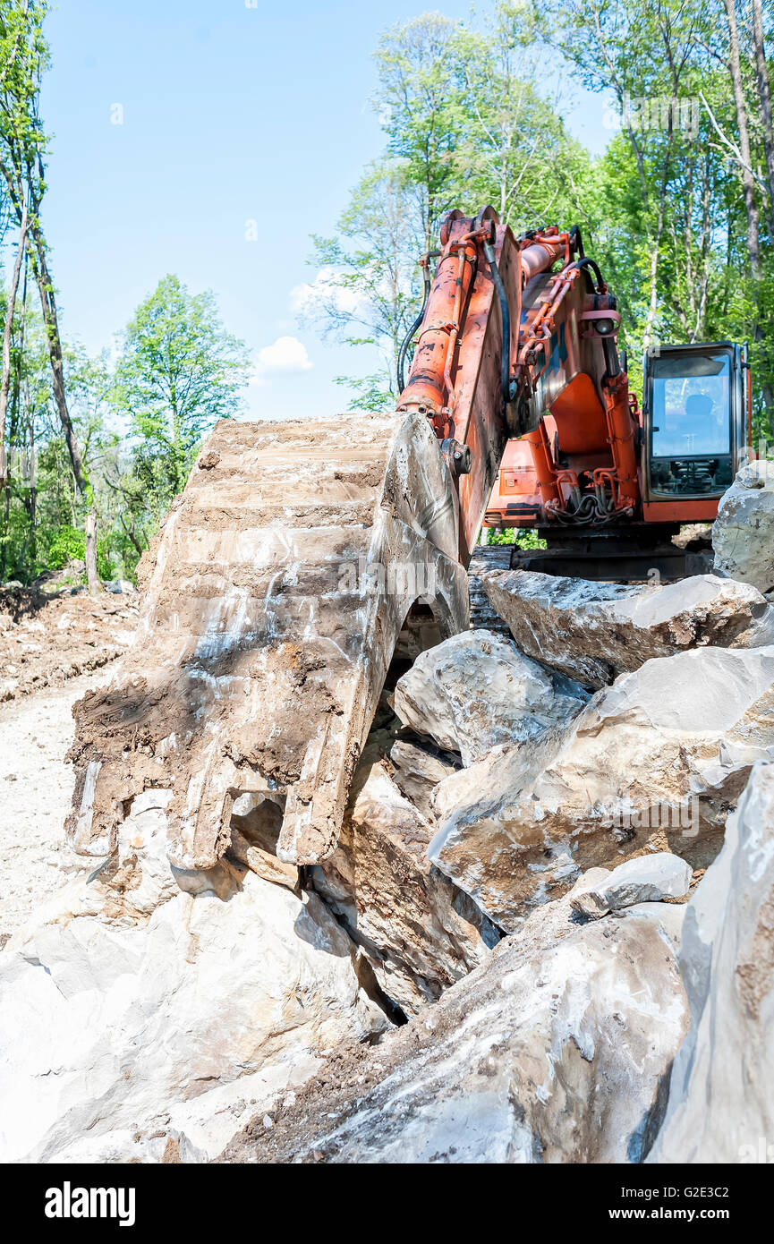 Excavator with big shovel to work with rocks Stock Photo - Alamy