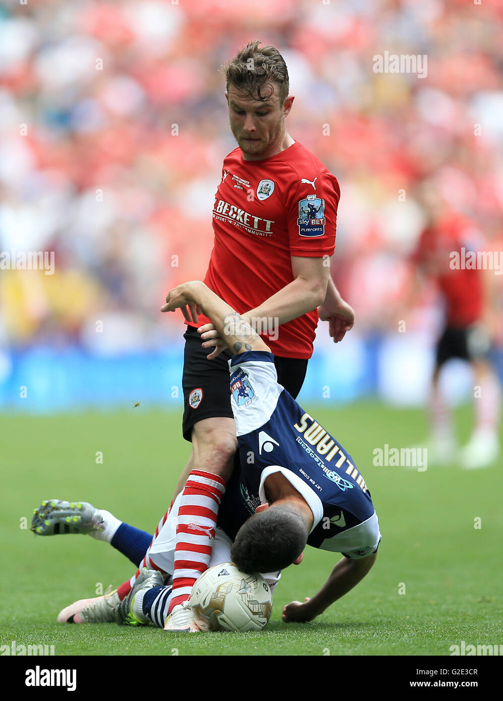 Barnsley's Sam Winnall (top) and Millwall's Shaun Williams battle for ...