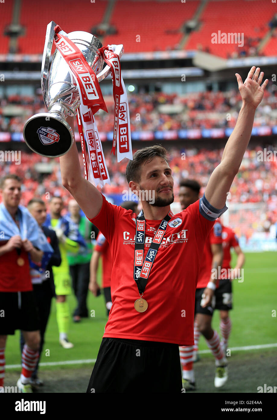 Barnsley's Conor Hourihane lifts the trophy after winning the Sky Bet ...