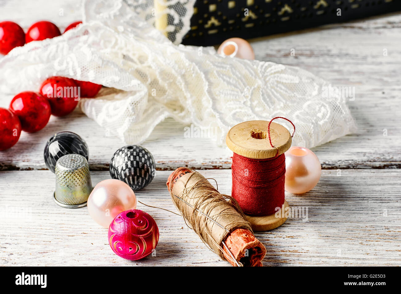 White lace,spool of thread and beads for needlework Stock Photo - Alamy