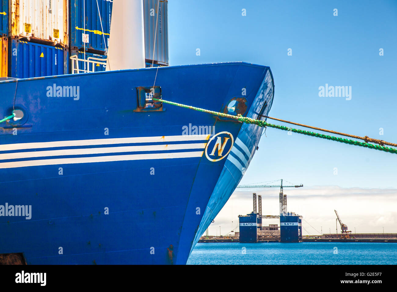Moored blue-coloured ship loaded with containers Stock Photo - Alamy