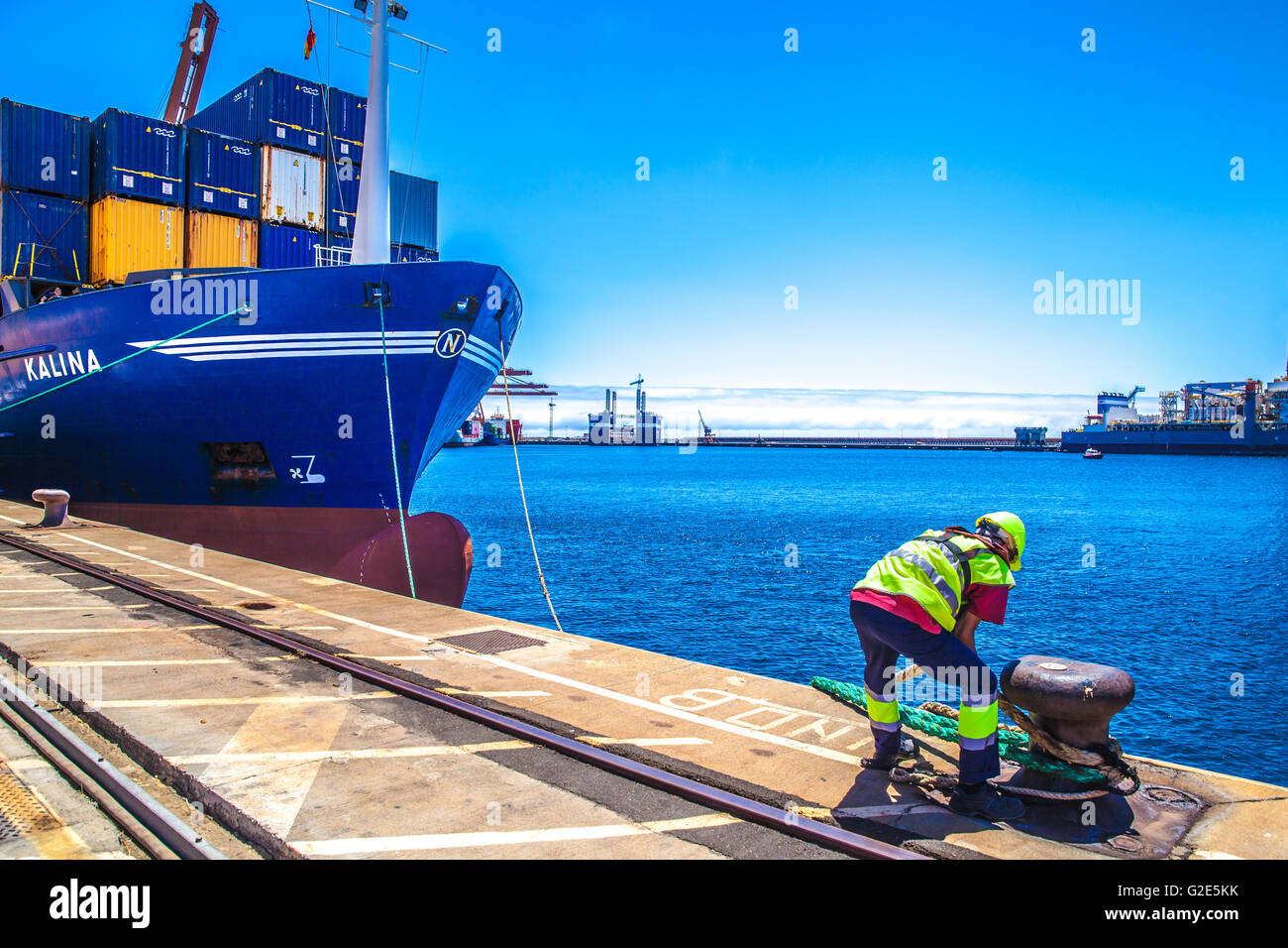 working man mooring a container ship Stock Photo - Alamy