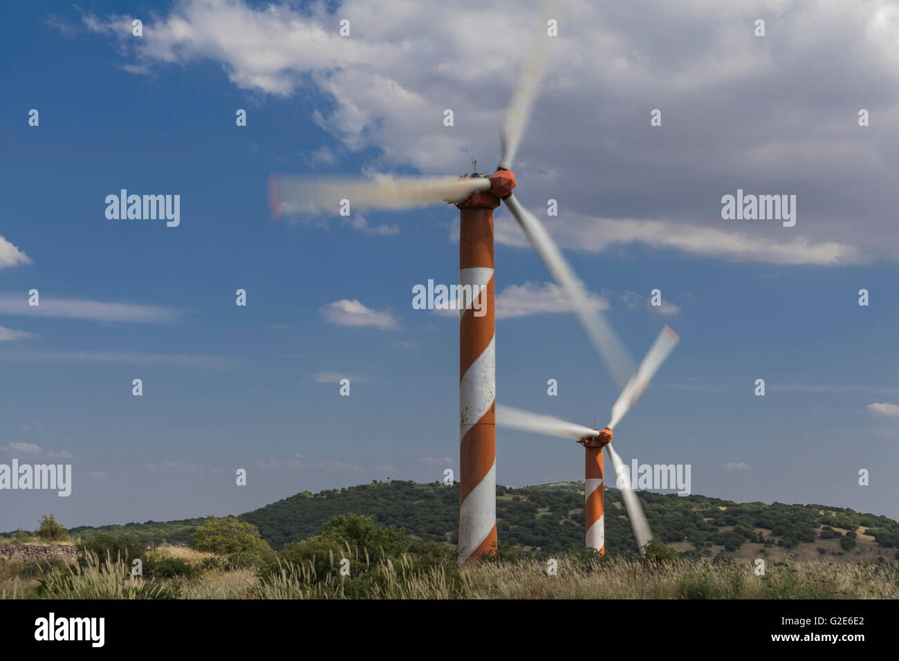 Two Orange windmill with motion on blue sky background with white ...