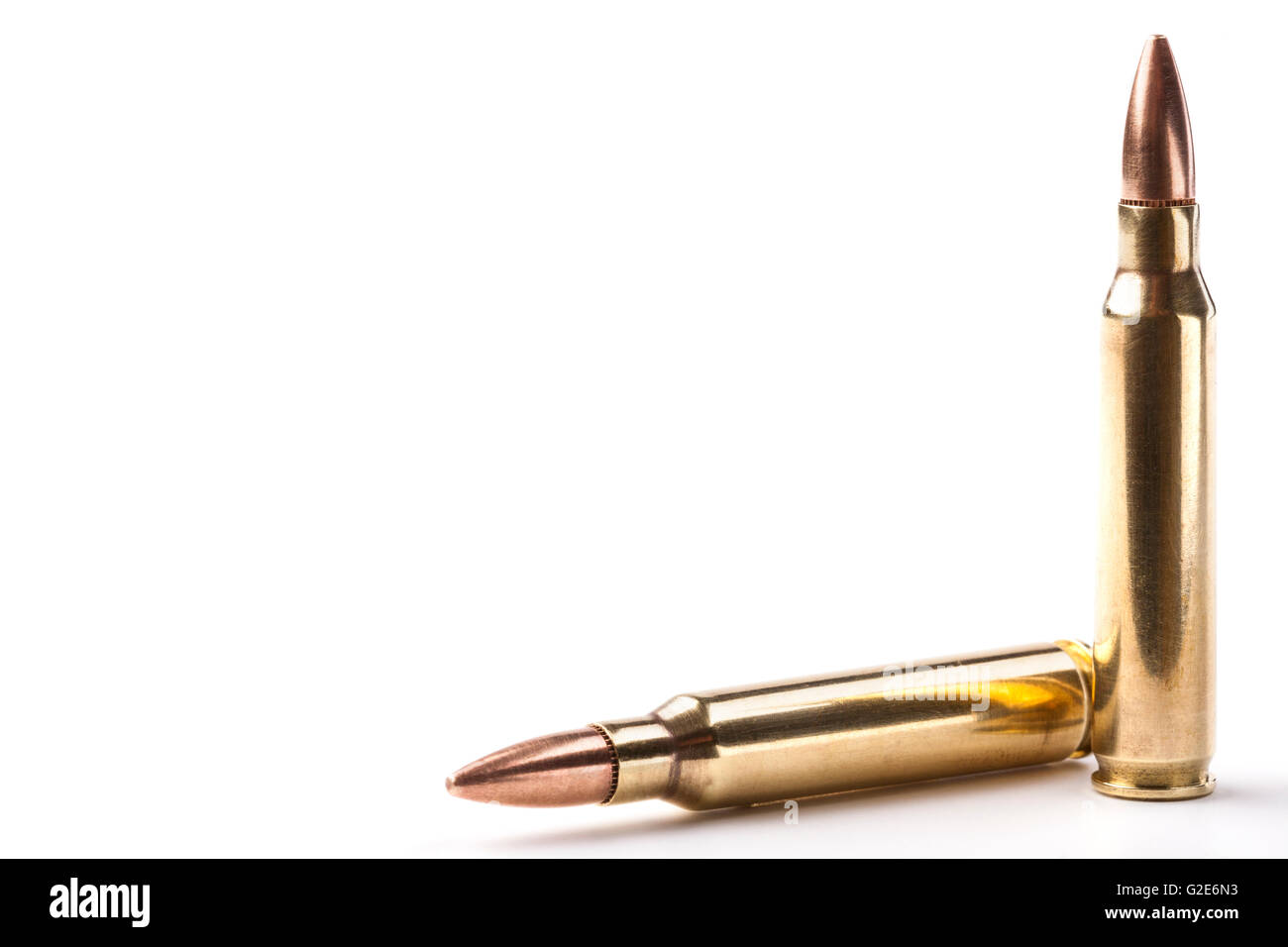 Two rifle bullets one vertical and the other orizontal isolated on ...