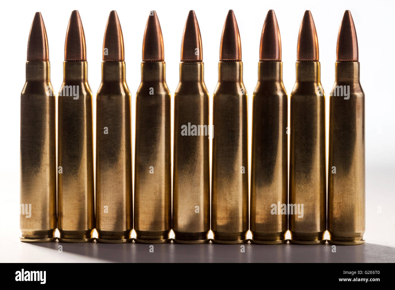 Rifle bullets in a row with shadow on white background Stock Photo - Alamy
