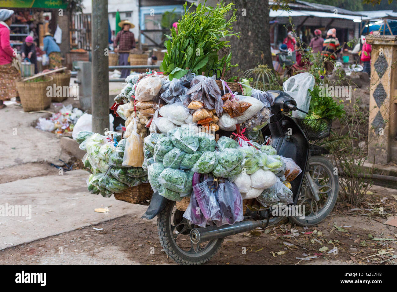 Motorbike full of vegetables, fruits and other food, in a market ...
