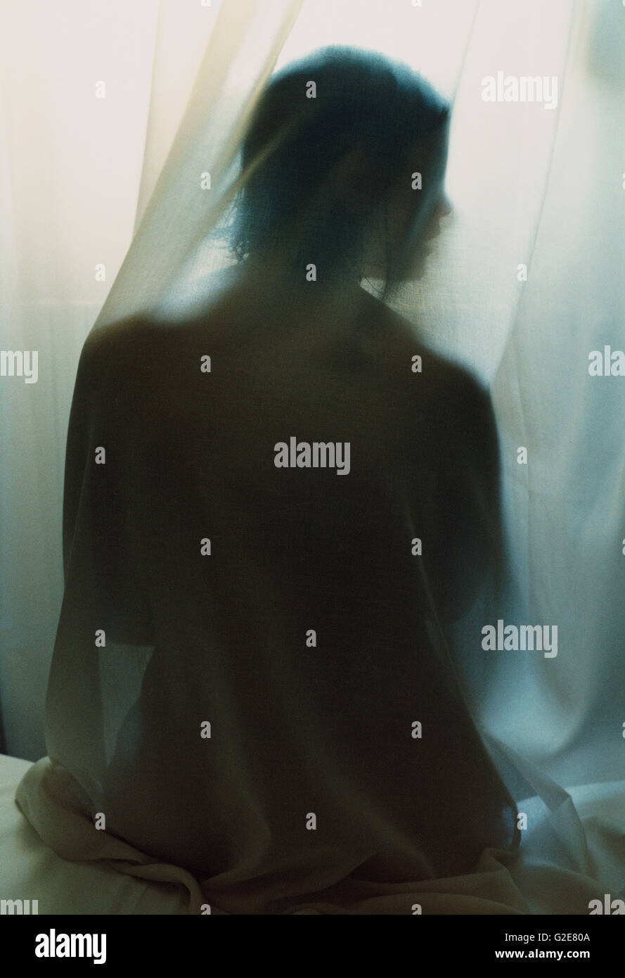 Figure Behind Sheer Curtain Stock Photo - Alamy