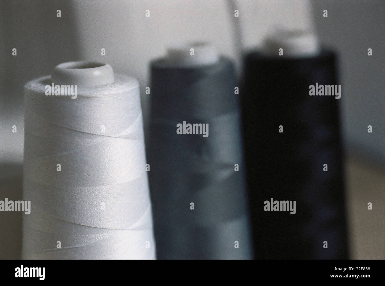 White, Grey & Black Spools of Thread Stock Photo - Alamy
