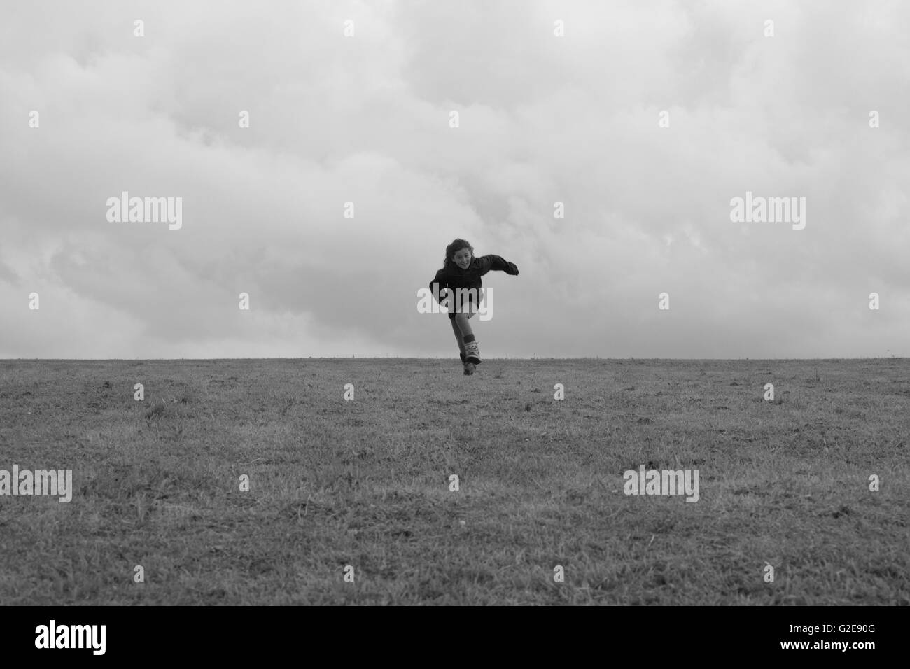 Young Girl Running in Field Stock Photo - Alamy