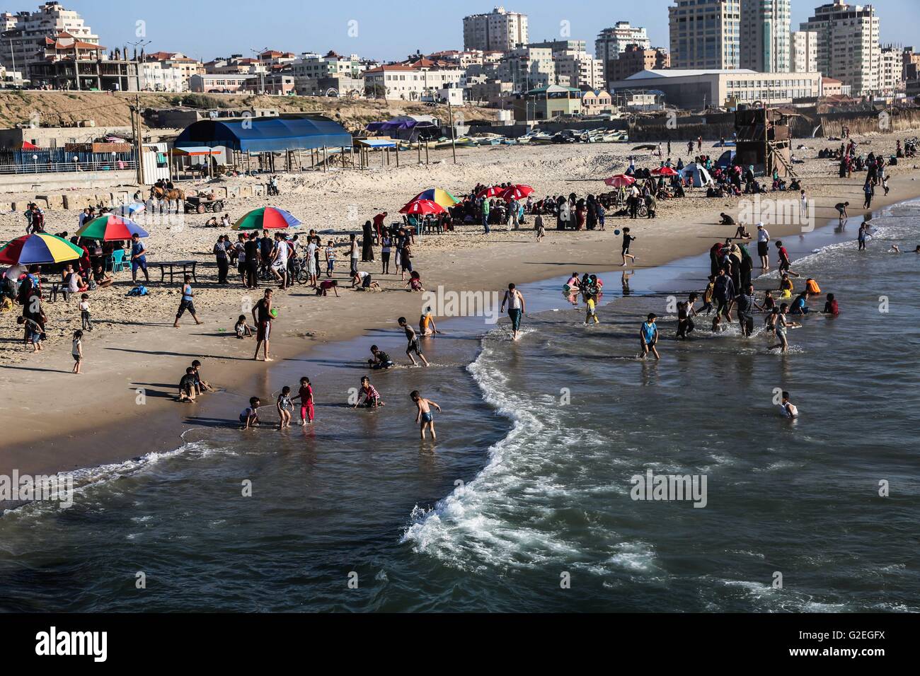Palestinians enjoy a day at the beach of the Mediterranean sea on the ...